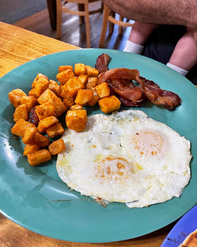 The breakfast trinity: perfectly cooked eggs, crispy home fries, and bacon that's achieved that mythical balance between chewy and crisp. Morning salvation!