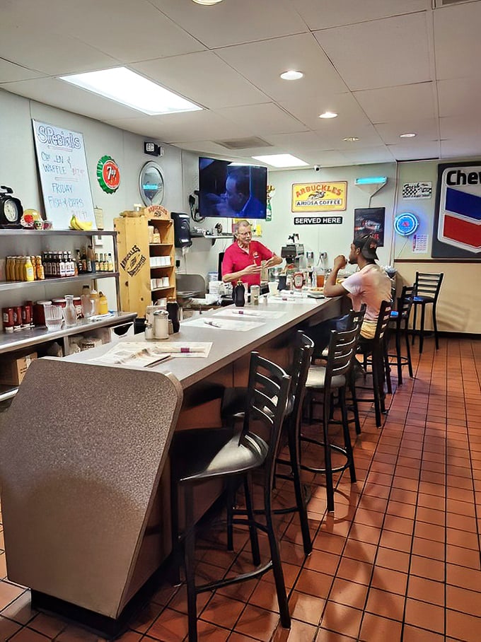 The classic diner counter where coffee flows freely and conversations happen between strangers becoming friends.