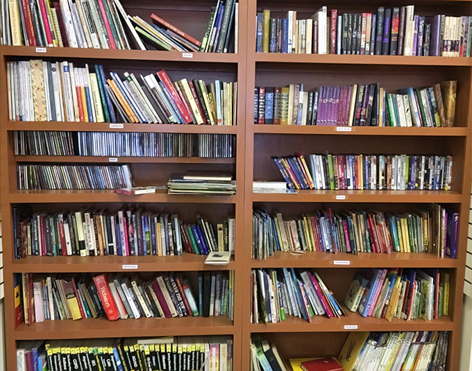 Books stacked with the precision of a literary Jenga tower. Someone's abandoned Stephen King could be your next sleepless night.