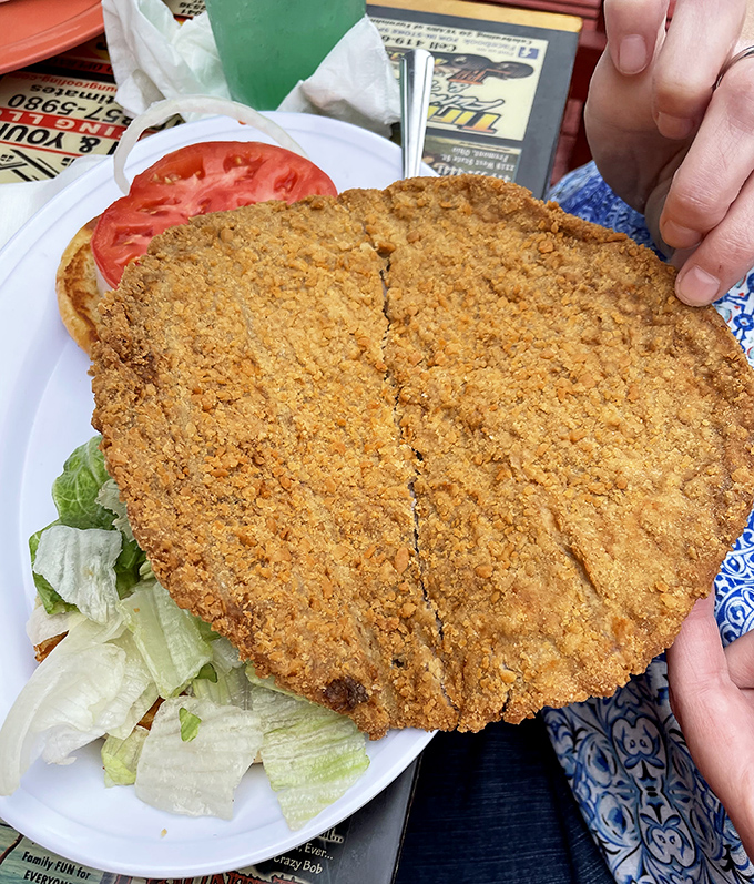 This breaded veal cutlet is so massive it needs its own zip code. Crispy, golden, and taking up real estate on a plate that barely contains it.