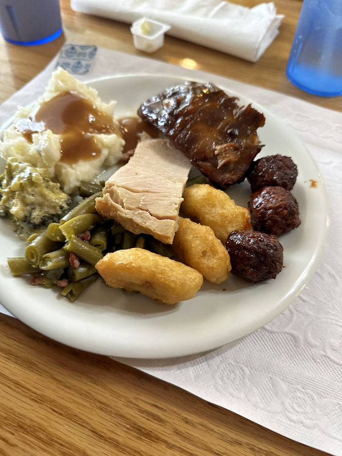 The buffet plate of champions &ndash; where green beans, mashed potatoes, and multiple proteins coexist in perfect harmony. This isn't a meal; it's an achievement.