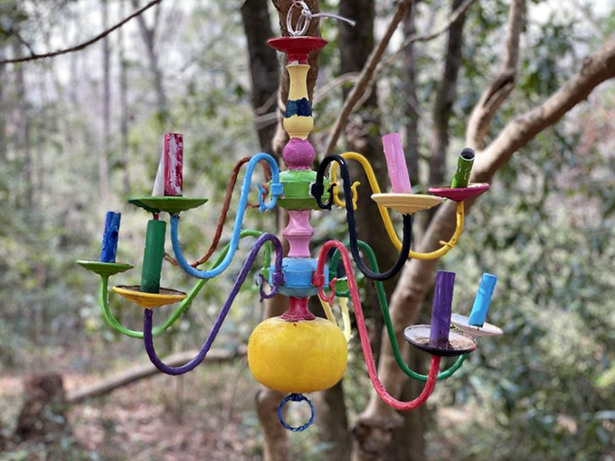 This whimsical, rainbow-colored chandelier hanging among the trees proves that sometimes the most unexpected decorations make the best garden accessories.