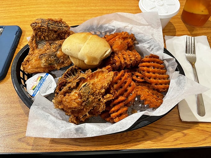 The holy trinity of comfort: crispy chicken, sweet potato waffle fries, and a soft roll&mdash;no fancy garnishes needed when the basics are this good.