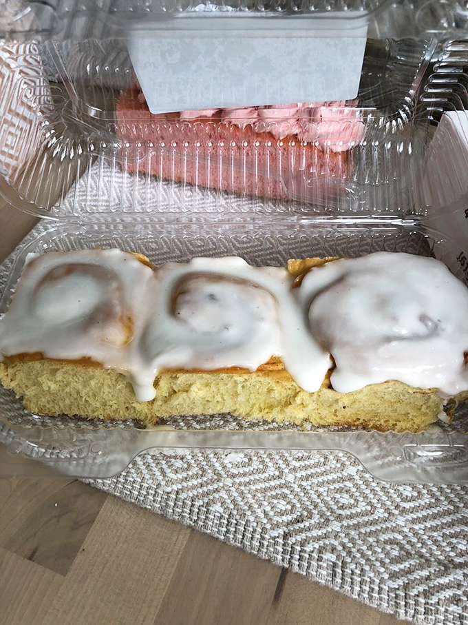 Cinnamon rolls with a side of frosting that makes you wonder if you should eat them with a fork or just face-plant directly into their swirled perfection.