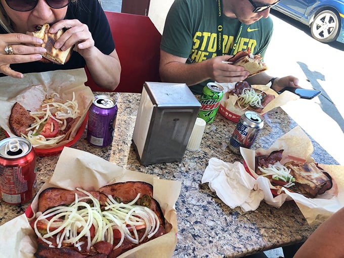The universal language of sandwich appreciation brings strangers together at Luigi's communal tables, united by sauce-stained fingers and contentment.