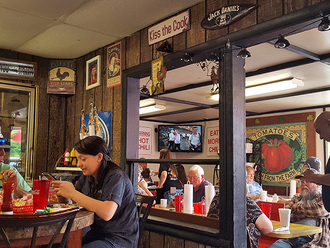 A dining room where conversations buzz like hungry bees and the tomato sign reminds you that yes, real food comes from somewhere real.