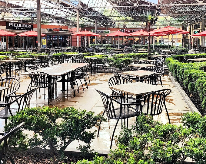 The dining area's lush greenery provides a tranquil oasis for weary shoppers to rest their feet and contemplate their next retail conquest.