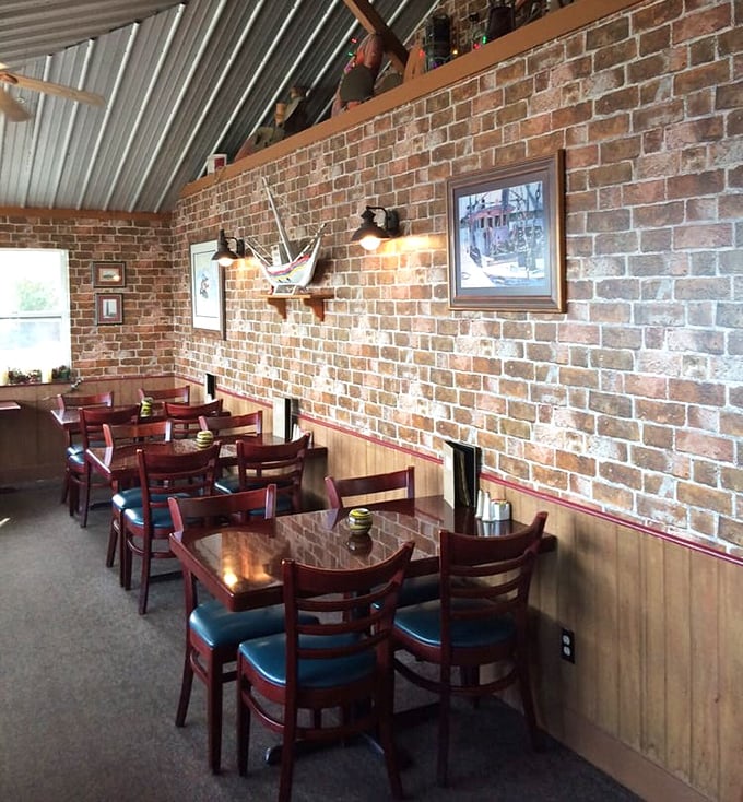 Dining room where brick walls meet wooden warmth. The nautical touches aren't from a designer's catalog&mdash;they're collected memories of life on the water.