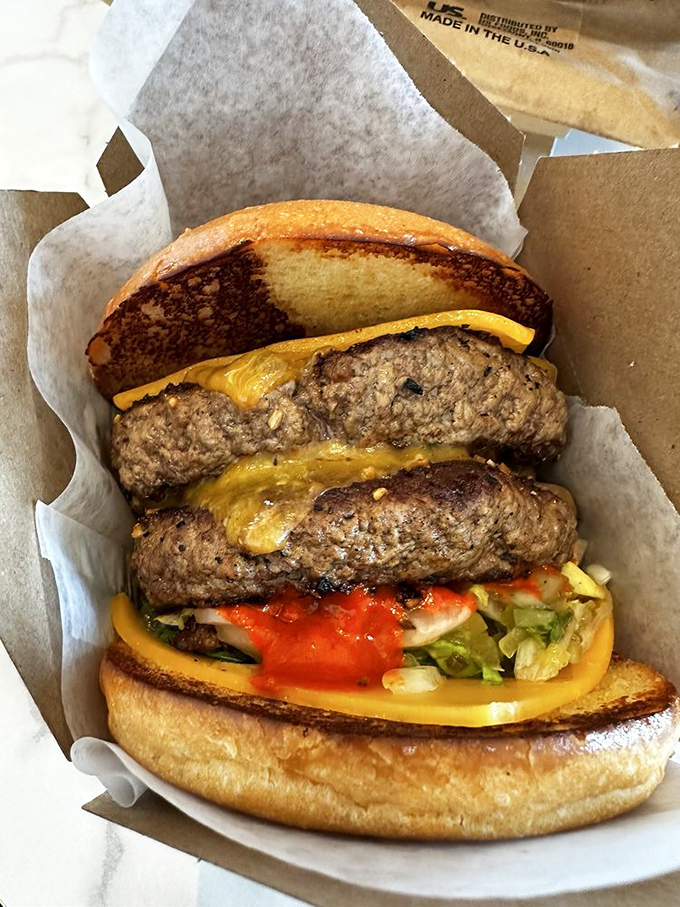 Behold the double-decker dream machine. Two patties means twice the flavor conversation happening in one magnificent sandwich.