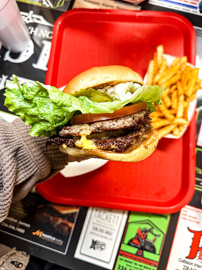 A double cheeseburger that requires a game plan before the first bite. Strategic napkin placement is strongly advised.