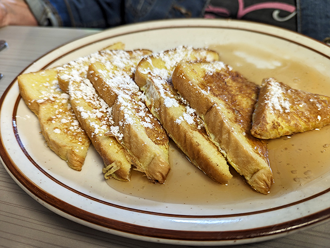 French toast that's achieved the impossible balance&mdash;crispy edges, custardy centers, and a dusting of powdered sugar that falls like delicious snow.