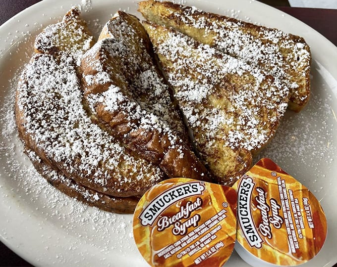 French toast that's achieved the impossible: crisp edges giving way to a custardy center, waiting patiently for its maple syrup baptism.
