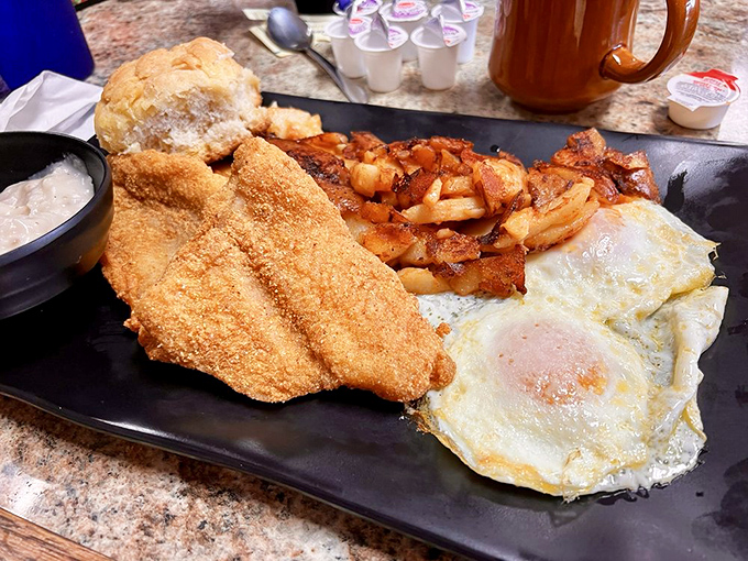 Fried catfish that would make a fisherman proud – golden, crispy coating protecting flaky white fish, with eggs and potatoes completing this Southern symphony.