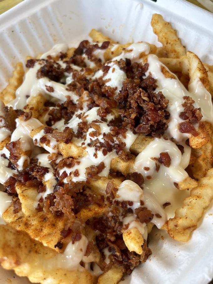 Loaded fries that require a game plan: Do you tackle the bacon first, or dive straight into that cheese sauce? Strategic eating at its finest.