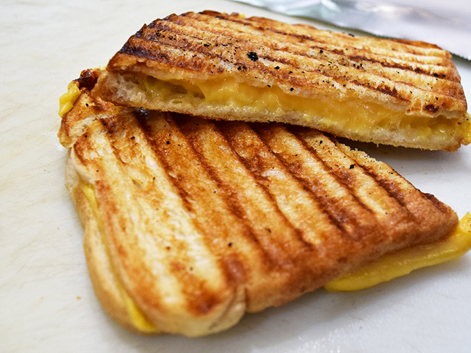 The humble grilled cheese, elevated to art form. That perfect golden crust hiding molten cheese is what childhood dreams are made of.