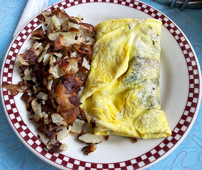 The perfect omelet doesn't exi— Oh wait, there it is, nestled next to hash browns that look like they've been crisped by angels.
