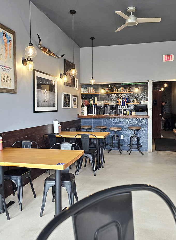 The industrial-chic interior strikes that perfect balance between casual comfort and authentic barbecue joint atmosphere throughout.