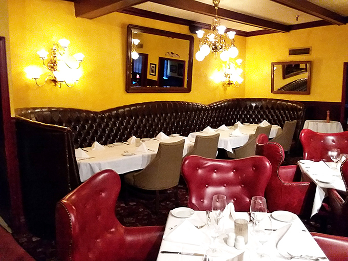 Red leather chairs and white tablecloths—the classic steakhouse uniform that signals you're about to have a meal worth remembering (and possibly unbuttoning your pants for).