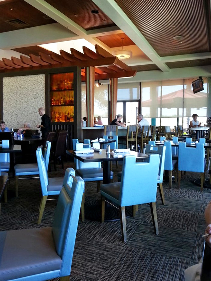 Architectural elements like wood-paneled ceilings and stone accents create a dining room that feels both contemporary and timeless.