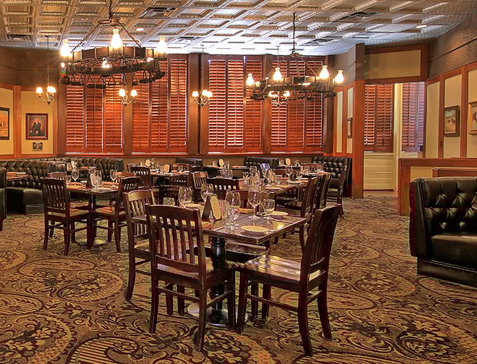 The dining room balances Western heritage with white-tablecloth refinement—where cowboys with expense accounts feel equally at home alongside anniversary celebrants.