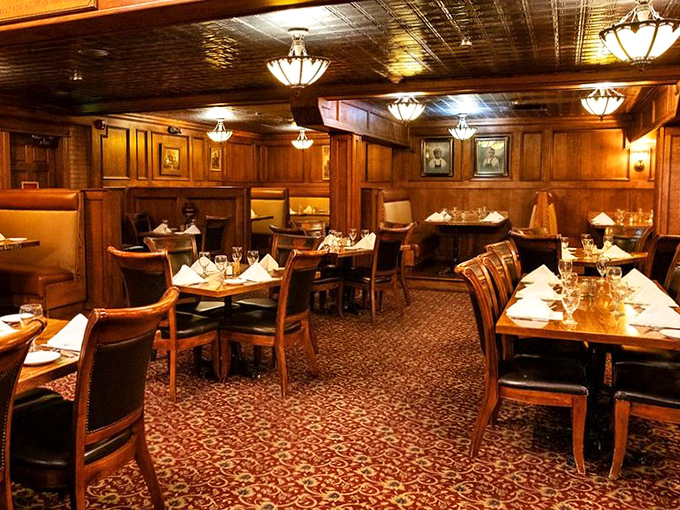 Dining room or time machine? The warm wood, elegant lighting, and meticulous table settings create an atmosphere that whispers, "Stay awhile."