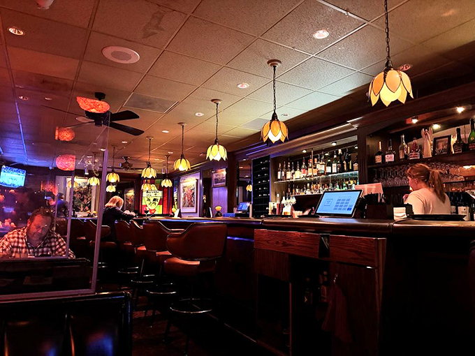 The dining room's warm glow from tulip-shaped pendant lights creates the perfect atmosphere for both business deals and anniversary celebrations.