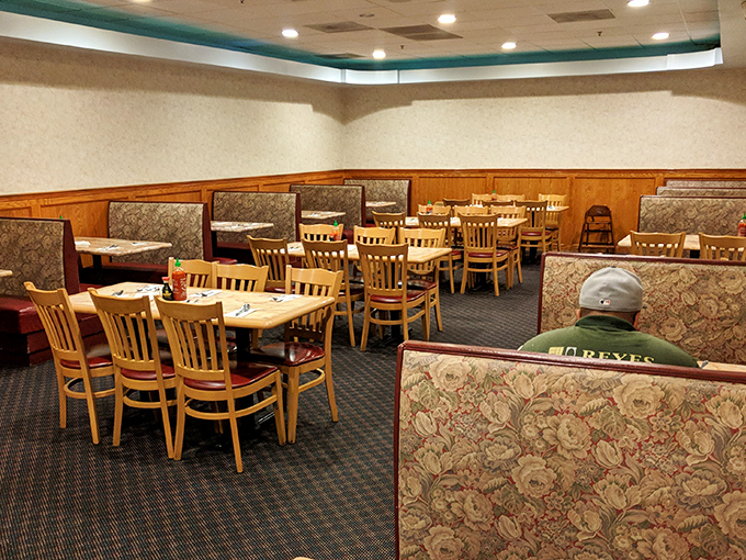 The dining room's booth section offers semi-private kingdoms for serious eaters. These floral thrones have witnessed countless food marathons.