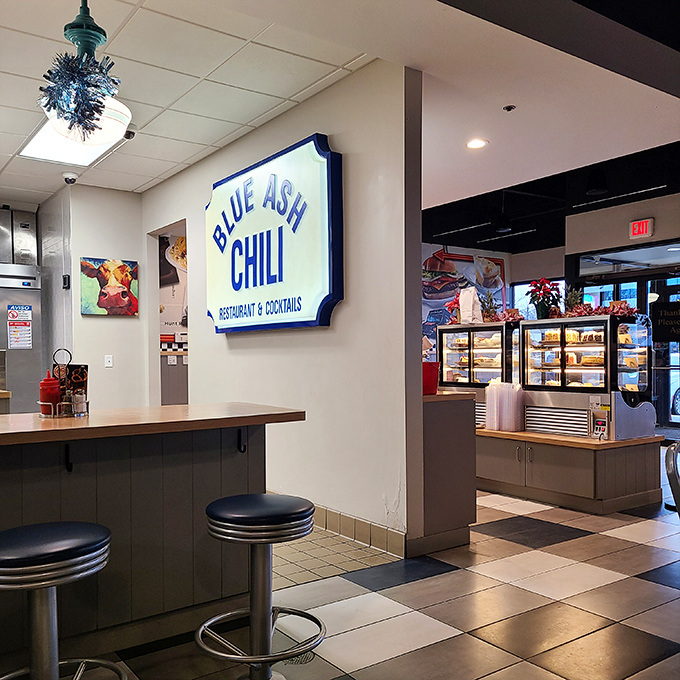 The interior balances retro charm with modern comfort. That Blue Ash Chili sign isn't just decoration&mdash;it's a beacon of hope for the hungry.