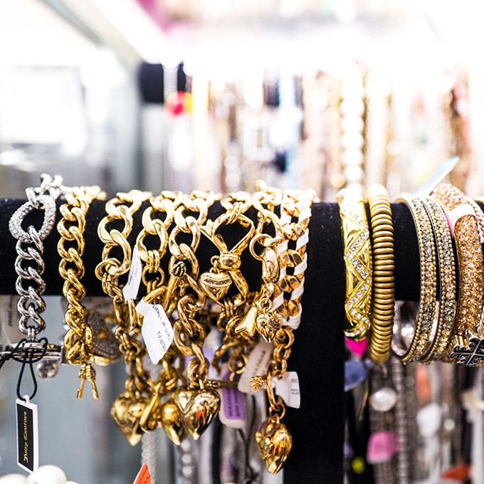 Golden jewelry displays catch light like miniature treasure chests, making everyday accessories feel absolutely regal.