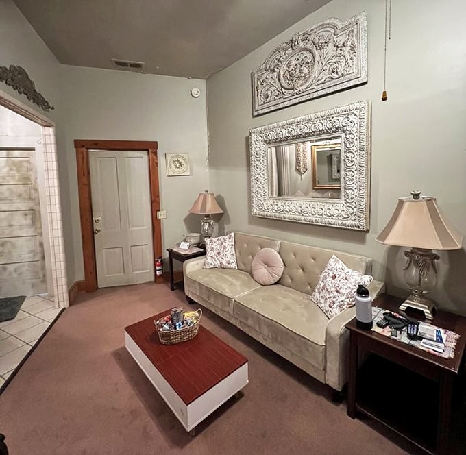 Plush velvet seating and ornate mirrors create a sitting area where you half expect to find a duchess's diary on the side table.