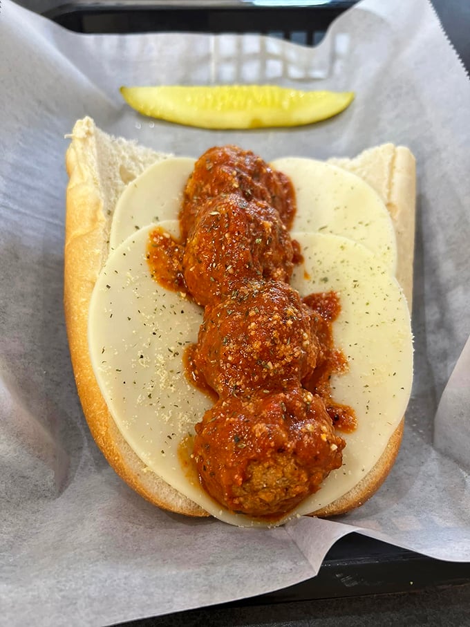 Meatballs nestled in a bed of melted provolone, like savory planets in a cheese galaxy. Houston, we have no problems here.