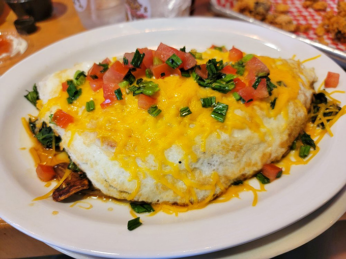 This isn't just an omelet&mdash;it's a cheese-draped sunrise on a plate, complete with fresh toppings that make breakfast feel like the celebration it should be.