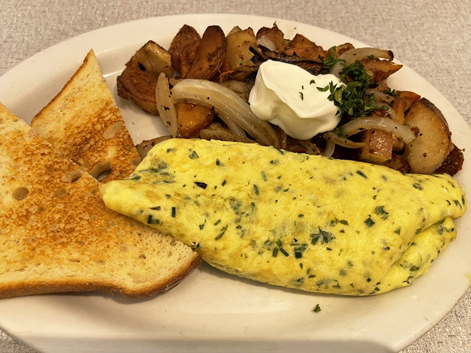 This isn't just an omelet&mdash;it's a fluffy yellow envelope delivering herbs and cheese alongside potatoes that have clearly been on a first-name basis with butter.