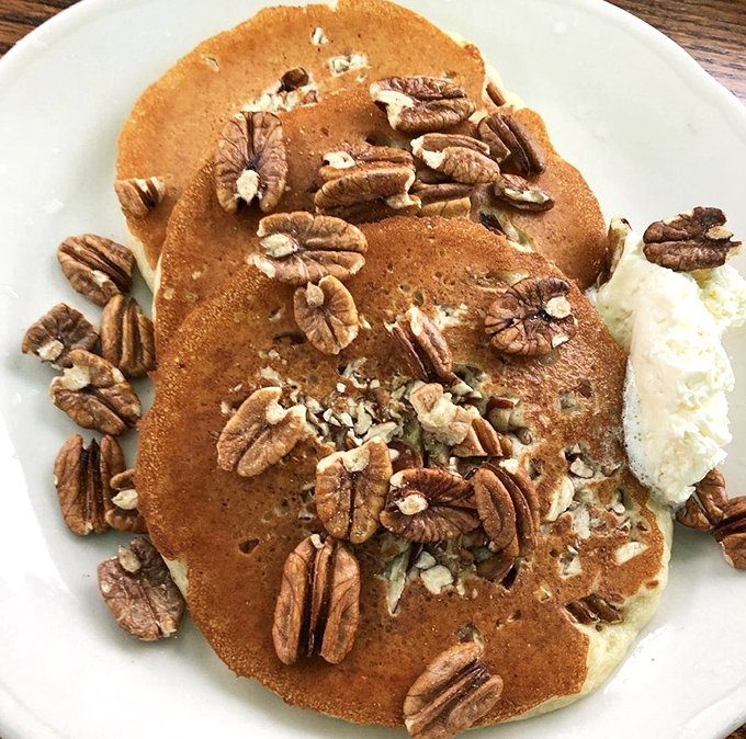 Georgia pecan pancakes with enough nuts to make a squirrel weep with joy. The dollop of whipped butter melts into pure breakfast bliss.