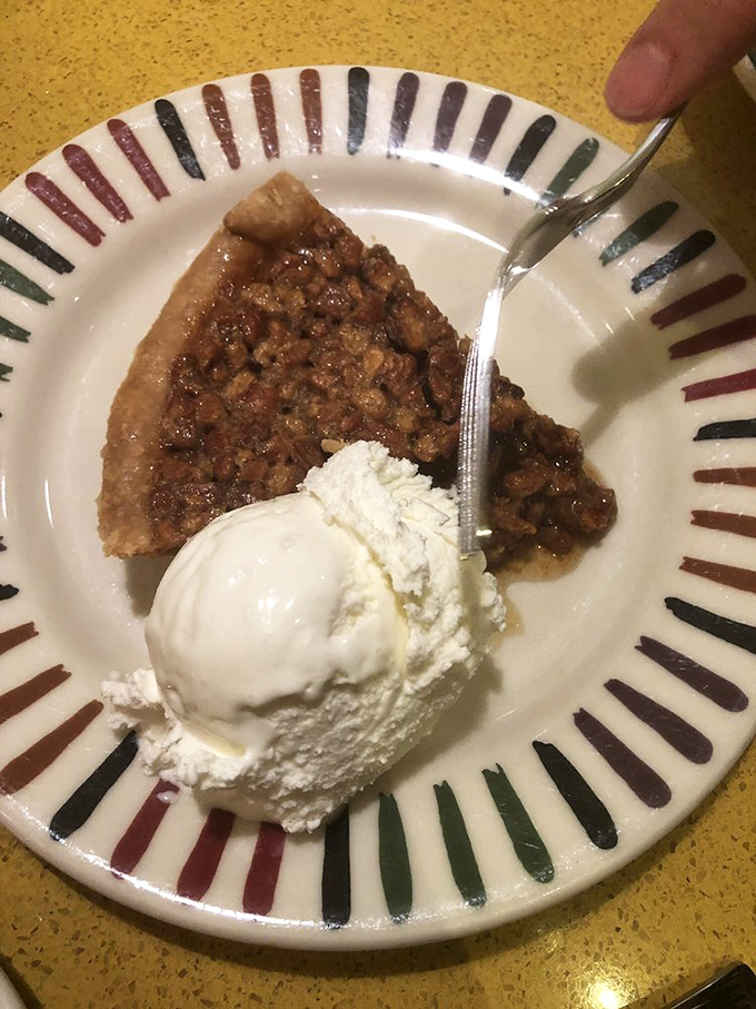 Pecan pie with ice cream: where Southern tradition meets cold comfort. The striped plate just adds to the carnival of delights.