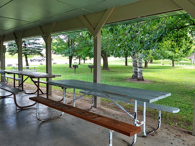 The community picnic shelter waits patiently for the next potluck, where three different versions of "secret recipe" potato salad will compete for neighborhood bragging rights.