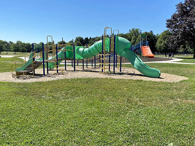 This playground's twisting green slides promise the kind of old-school childhood joy that no video game can replicate &ndash; pure gravitational delight.