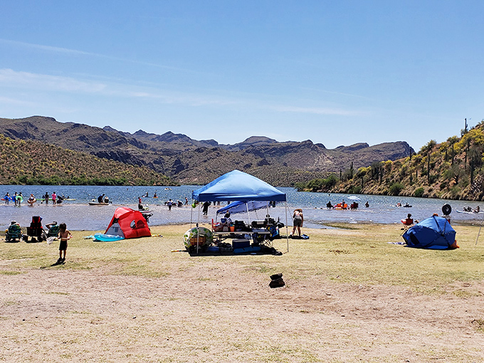 Weekend real estate at Butcher Jones Beach &ndash; where families stake temporary claims with colorful canopies against a backdrop worthy of National Geographic.