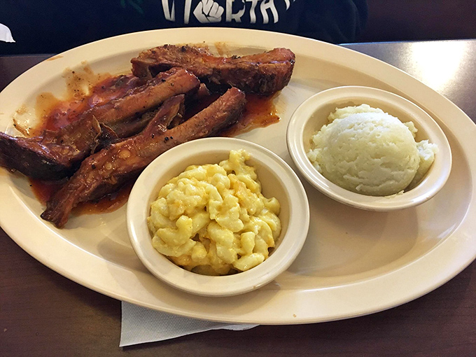 Ribs that don't just fall off the bone—they leap willingly into flavor paradise. The mac and cheese isn't a side; it's a co-headliner in this soul food concert.
