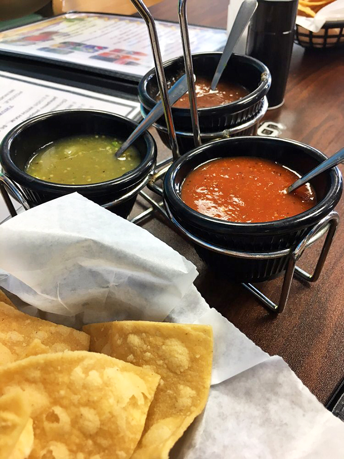 The salsa trinity&mdash;each small bowl containing multitudes of flavor. Choose your adventure: mild refreshment, medium excitement, or full-throttle heat that demands respect.