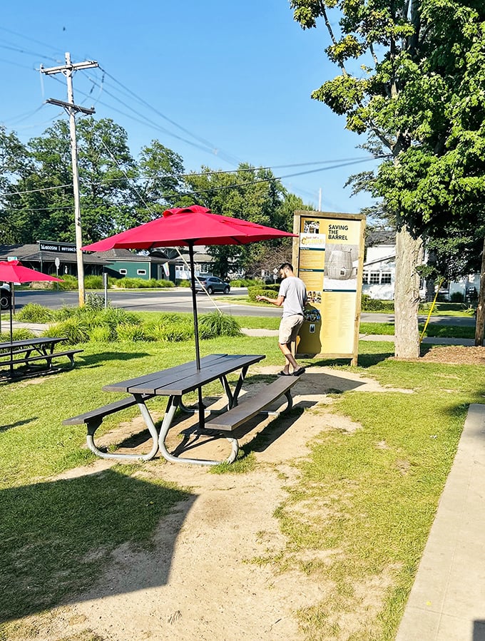 A sign tells the barrel's story while picnic tables wait patiently for the next round of hungry travelers seeking roadside magic.