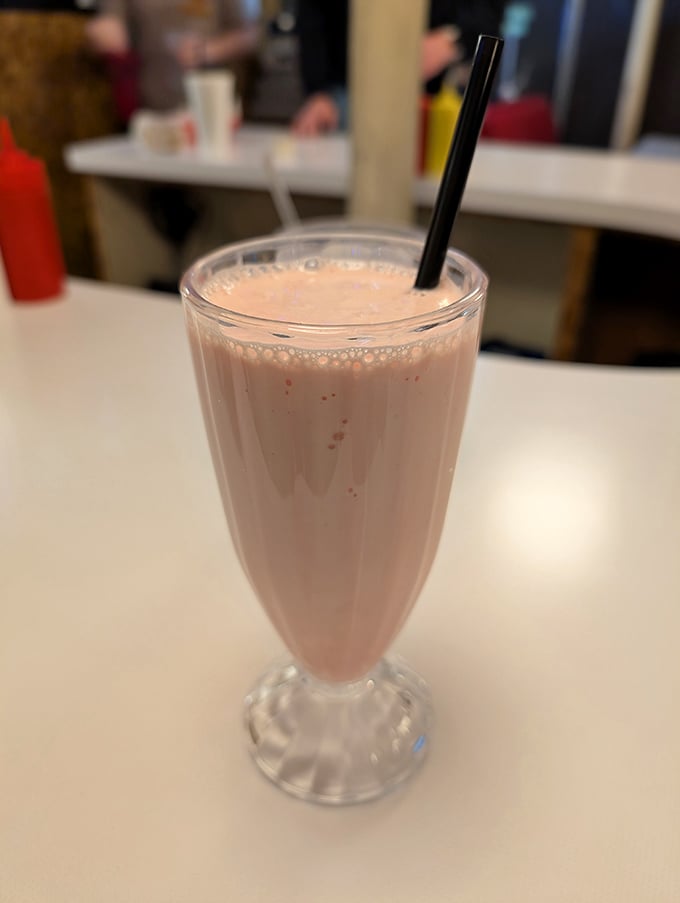 This strawberry shake isn't just thick—it's contemplating a career change to become soft-serve ice cream.