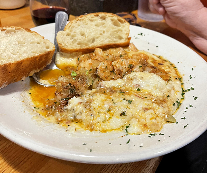 Shrimp and grits that tell a Southern story &ndash; creamy, cheesy goodness topped with perfectly seasoned shrimp and a side of crusty bread for sopping.