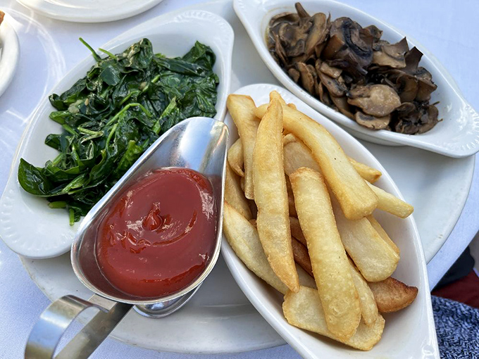 The supporting cast deserves applause too. Saut&eacute;ed spinach, golden fries, and mushrooms that have clearly been introduced to butter and loved it.