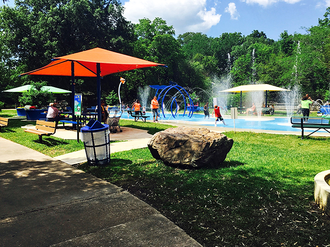 Kids dash through cooling fountains at this splash pad, finding summer joy in the universal language of "run through water, squeal with delight."