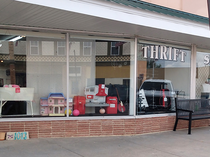 Ellis Community Thrift Shop's charming storefront window displays toys that spark nostalgia for simpler times.