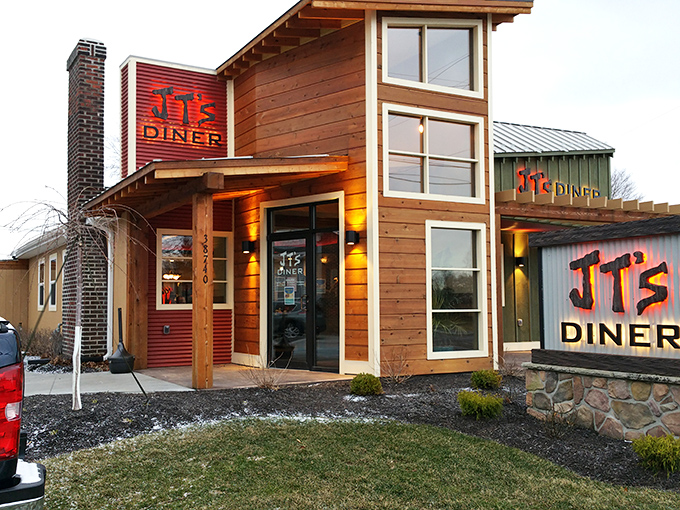 JT's wooden facade with its bold red signage feels like a cozy cabin that happens to serve breakfast instead of housing lumberjacks.