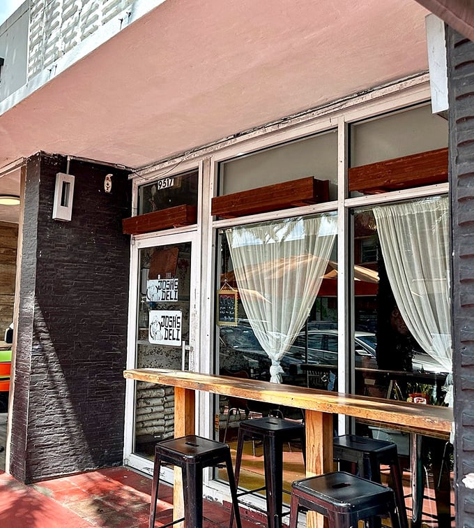 Josh's Deli's window counter seating &ndash; where watching your sandwich being crafted becomes performance art worth the ticket price.