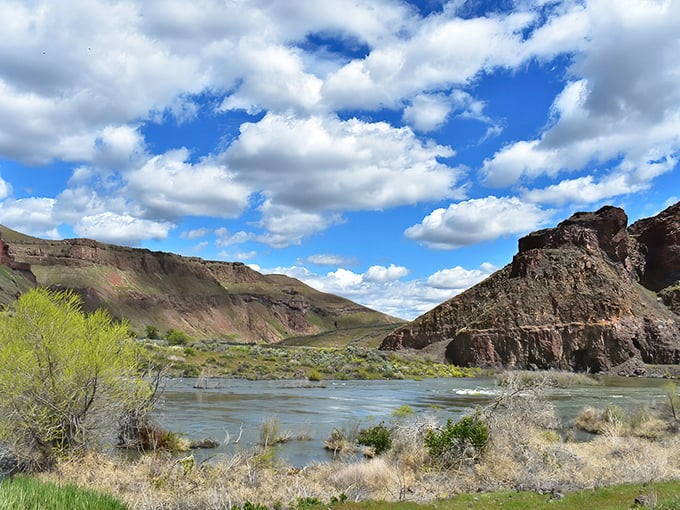 Red cliffs meet blue waters in a desert oasis that looks borrowed from Mars.