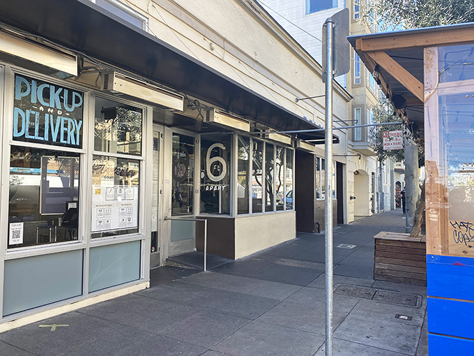 Pizzeria Delfina's sleek black exterior brings a touch of San Francisco sophistication to the humble pizza joint concept.